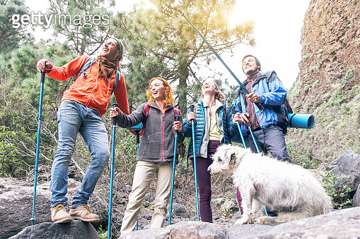 Group of friends with backpacks doing trekking excursion on mountain ...