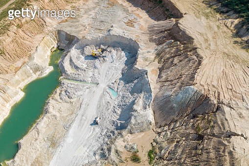 An old gypsum quarry filled with blue and pure water. Aerial view, from ...