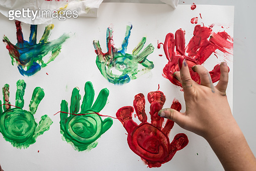 Hand of a child making red and green colourful palm prints (1034539628 ...