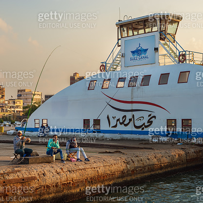 Local citizens of Port Fuad district fishing beside Port Said ferry ...