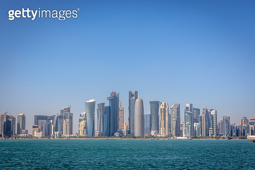 The skyline of Doha, Qatar, on a blue sky day, winter time, seen from ...