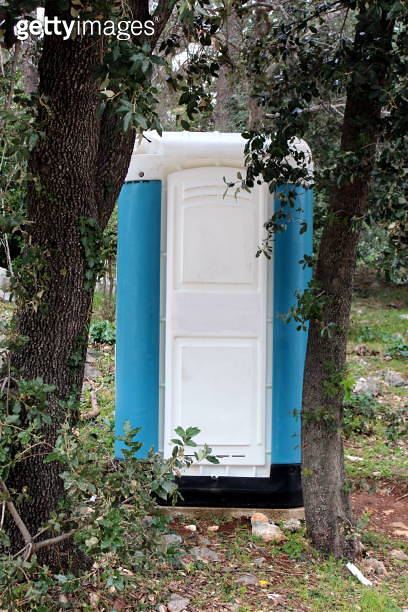 Portable blue and white ecological toilet behind tall trees (1080857016 ...