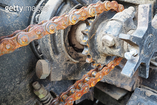 Chain drive. Rusty driving roller chain on the drive sprocket in ...
