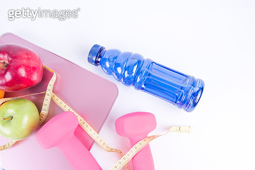 Top view of dumbbells, water, pink scale, fruit and tape measure 이미지 ...