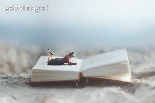 Woman Reads Her Book Lying On A Giant Book 이미지 1071660726 게티이미지뱅크