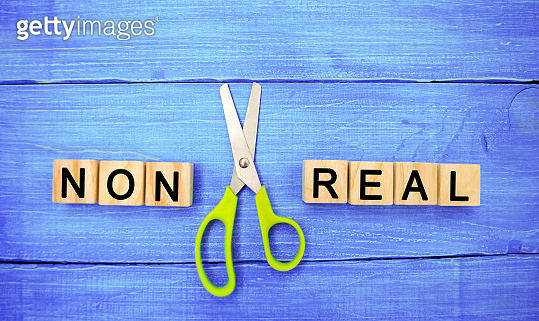 concept of motivation. the inscription 'non real' and scissors between ...