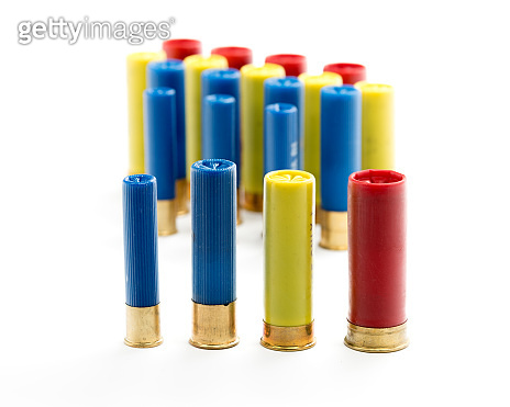 Four different shotgun shell sizes that are all different colors ...