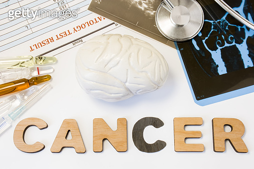 Brain cancer concept. Anatomical shape of brain lies near word cancer ...