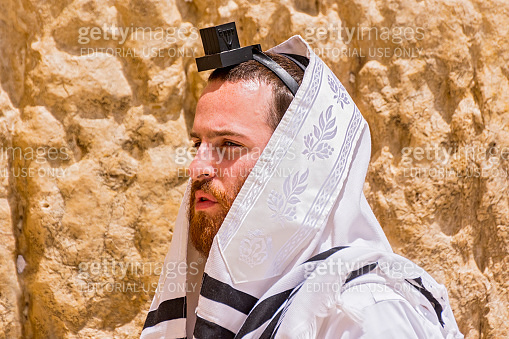 Ultra Orthodox Jew wrapped with traditional religious Talit shawl and ...