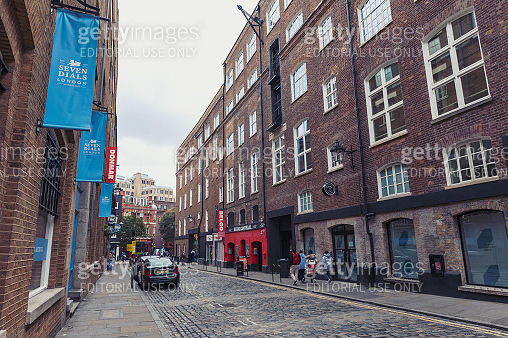 Cobbled alley of Earlham Street seen from the Seven Dials circular road ...