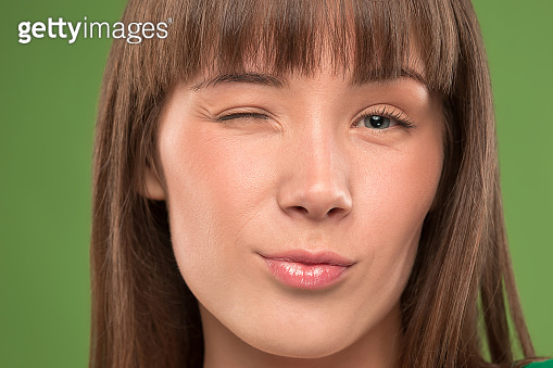 Close up portrait of a pretty young woman winking 이미지 (1026406392) - 게티 ...