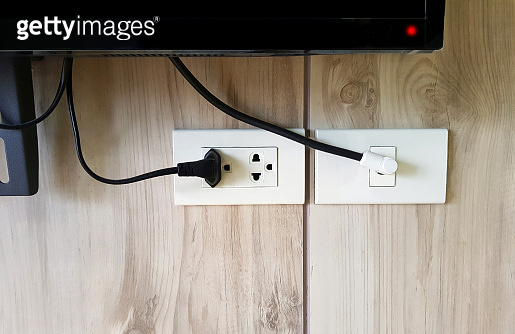 An electrical socket and TV outlet in the drywall in the room of in ...