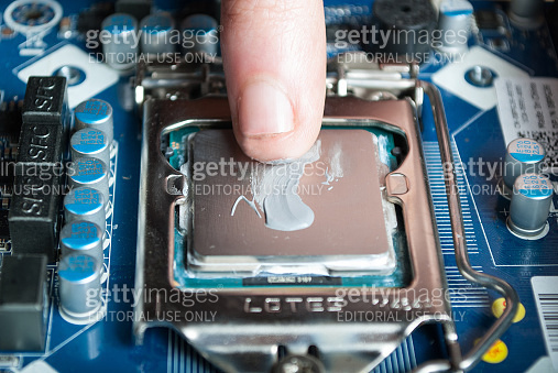 Applying thermal paste with finger during CPU Intel i5 installation on ...