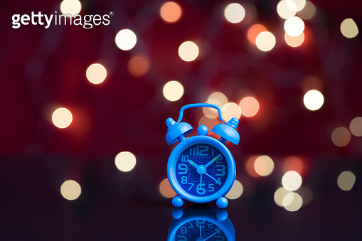 Time to wake up to work, blue alarm clock with party decoration light ...