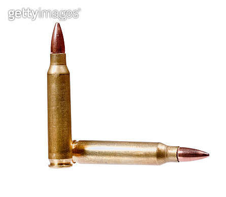 Two rifle bullets one vertical and the other horizontal isolated ...