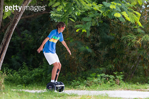 Child on hover board. Kids riding scooter (990588834) - 게티이미지뱅크