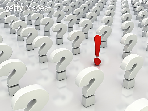 One red exclamation mark standing out from white question marks on ...