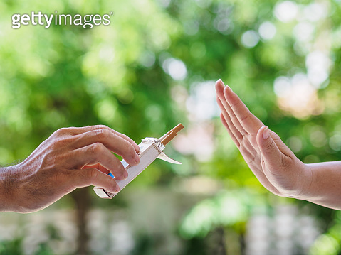 No smoking. Close up of male hands holding cigarettes and proposing it ...