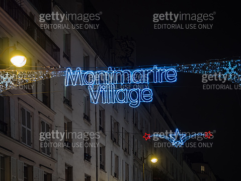 Illuminated sign with the words 'Montmartre Village' placed at the ...