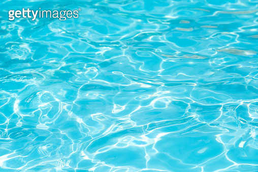 Blue and bright water in swimming pool with sun reflection, Motion of ...