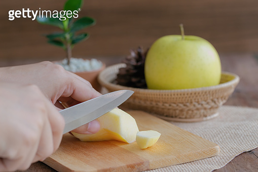 Woman use knife kitchen to chopped or cut and sliced fresh Shinano gold ...