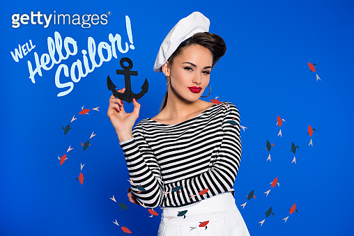 portrait of fashionable young woman in retro clothing with anchor in ...