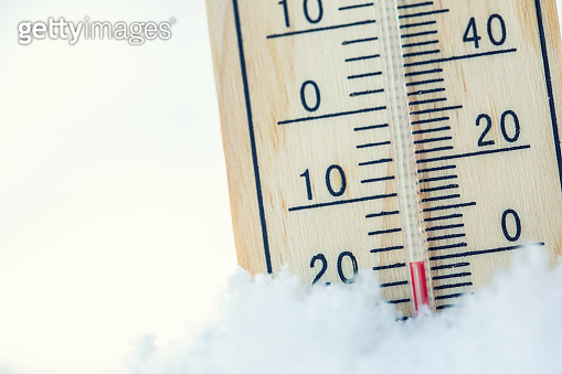 Thermometer on snow shows low temperatures under zero. Low temperatures ...
