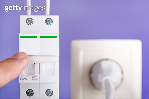 Electrician turns of the switch. Power outage. Energy saving concept ...