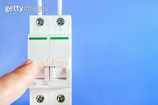 Electrician turns of the switch. Power outage. Energy saving concept ...