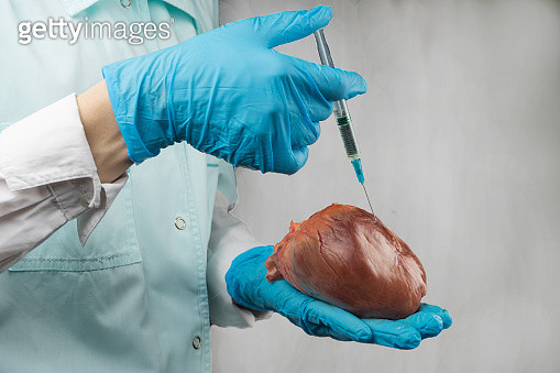 The medical worker makes an injection of the drug into the heart. Dark ...