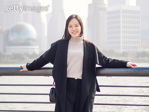 Outdoor portrait of young beautiful fashionable playful Chinese lady ...
