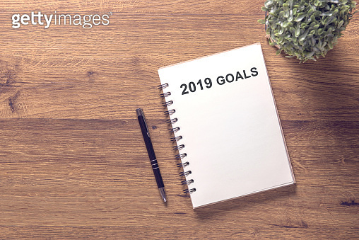 2019 goals list in notebook with gift box new year on wooden table ...