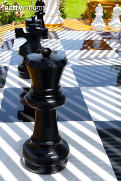 Chess piece queen in front of white and black background with clipping ...