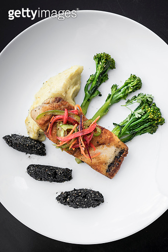 red snapper fish fillet with vegetables and black rice with black ...