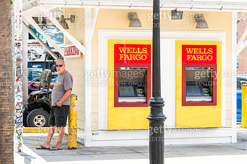 Wells Fargo bank branch atm machines with red, yellow sign, man, person ...