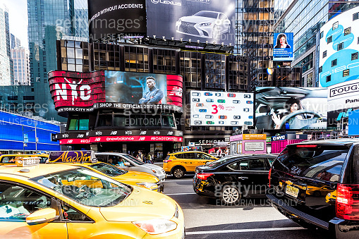 Manhattan NYC buildings of midtown Times Square, Broadway avenue road, signs ads, many yellow ...