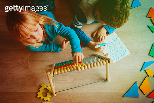 little boy and girl learn to write and calculate numbers (931244334 ...