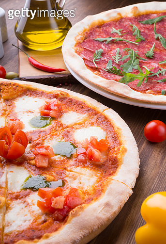 Two different pizzas freshly baked 이미지 (1067691134) - 게티이미지뱅크