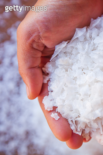 Pure white crystals salt, rock salt in women hands on crystals ...