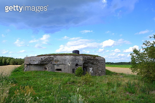 An old abandoned grey concrete bunker ruin standing on a hill near to a ...