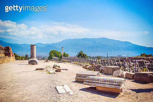 Panoramic view of ancient city, ruined ancient columns and volcano ...