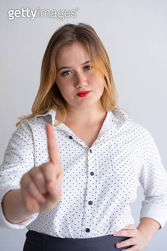 Serious strict showing warning sign (1056257396) - 게티이미지뱅크