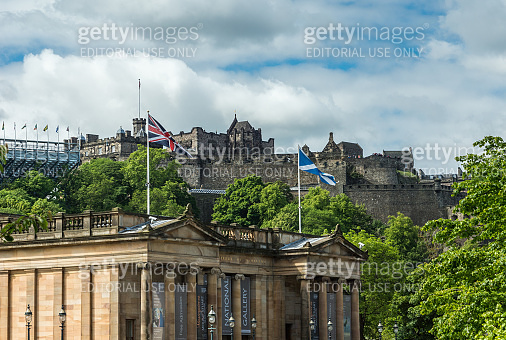 Castle of Edinburgh towers over Scottish National Gallery, Scotland UK ...