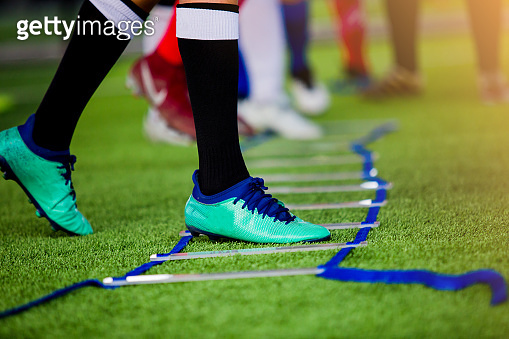 Young boy soccer players Jogging and jump between ladder drills for ...