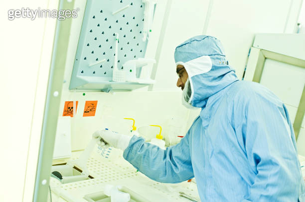 Asian Research Scientist Rinsing/Etching Semiconductor Wafer - After ...