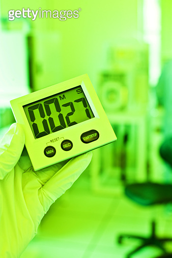 Scientist Inspecting A Tool (Digital Stopwatch Timer) In A ...