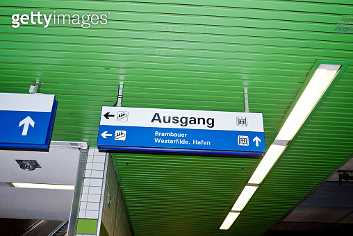 Illuminated Exit Sign (Ausgang in German) at a train station. Colourful ...