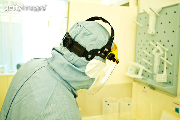Scientist Wearing Visor (Head / Face Protection) In A Cleanroom During ...