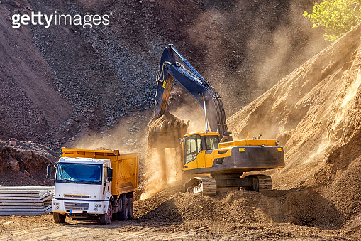 Excavator is loading excavation to the truck. Excavators (hydraulic ...