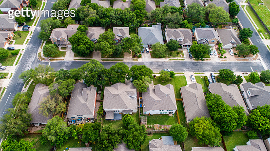 Two rows of homes aerial drone view looking down on rooftop in suburb ...